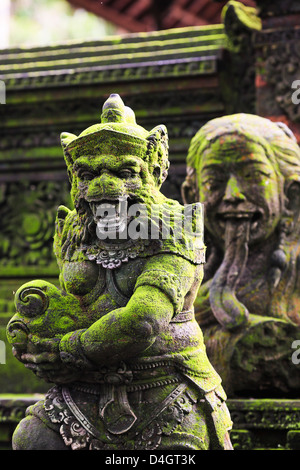 Statues covered in green moss on Monkey Forest Ubud, Bali Stock Photo ...