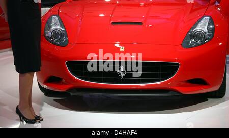 A hostess poses at the Ferrari booth of the Los Angeles Auto Show in ...