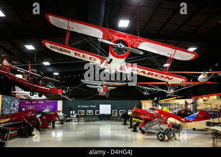A Red Baron Stearman hands above other exhibits inside the Sun n Fun ...