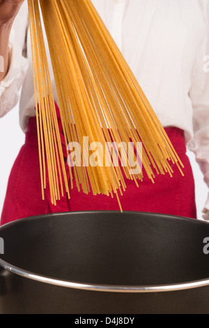 hands holding a bunch of raw spaghetti and cook it. italian noodle ...