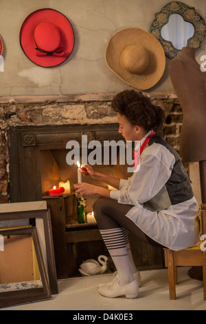 Young woman lighting candles in Our Lady of Lebanon sanctuary, Harissa ...