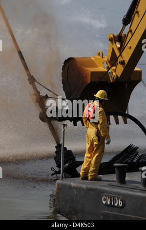 Crews work to shut in damaged wellhead Stock Photo - Alamy