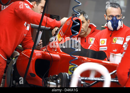 Ferrari Formula One mechanics work on race car in garage Stock Photo ...