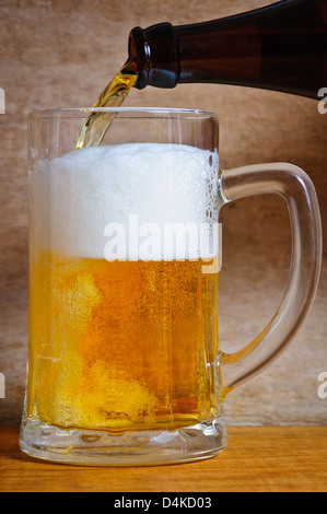 Beer pouring into mug Stock Photo - Alamy