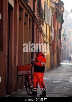 A post man delivers letters in Woking, Surrey Stock Photo - Alamy