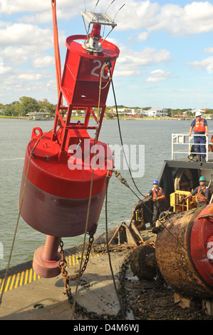A Coast Guard Cutter Maria Bray crew member gives the signal to deploy ...