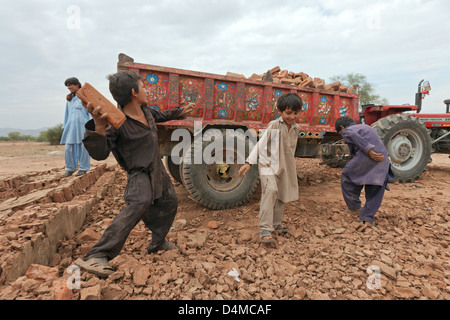 Boys throwing bricks Stock Photo - Alamy