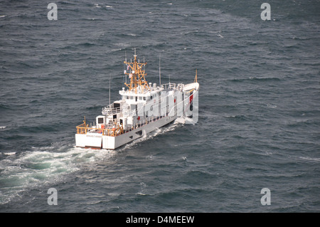 US Coast Guard Sentinel-class cutter sailing in front of the Statue of ...