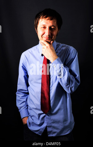 Male with greedy smile on dark background Stock Photo - Alamy