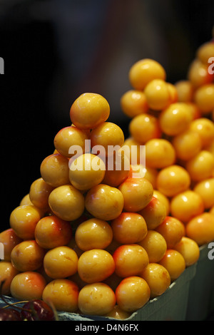 Ripe yellow rainier cherries at a fruit stall in the market Stock Photo ...