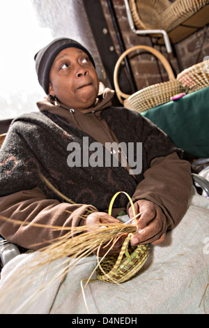 Gullah woman weaving sweetgrass baskets at the Historic Charleston City ...