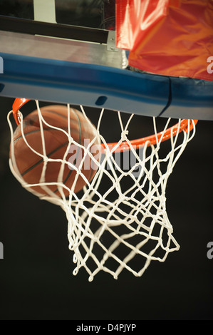 Basketball going through the hoop Stock Photo - Alamy