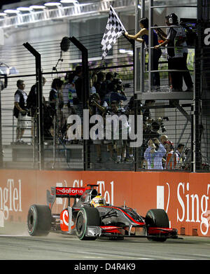 Mercedes driver Lewis Hamilton crosses the finish line to win the ...