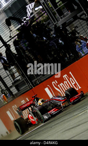 Mercedes driver Lewis Hamilton crosses the finish line to win the ...