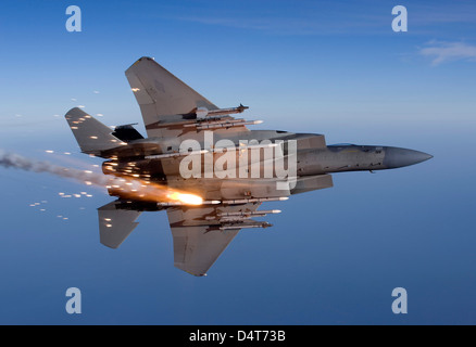 An air-to-air underside view of an F-15 Eagle aircraft from the 555th ...