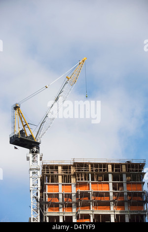 Building crane at a skyscraper in construction Stock Photo - Alamy