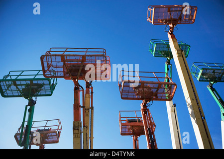 Low angle view of cherry pickers Stock Photo - Alamy