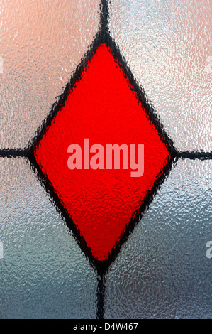 Diamond-shaped stained glass window aove basin in vanity unit in ...