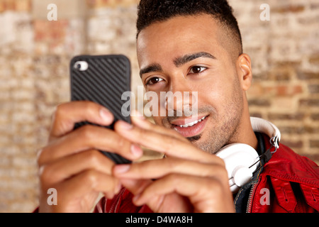 Smiling man using cell phone Stock Photo - Alamy