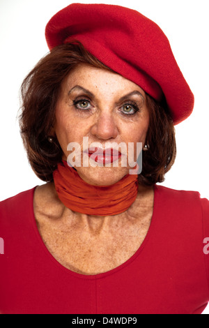 Senior woman wearing red clothes, taking a selfie with red headphones ...