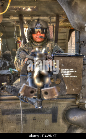 UH-60 Black Hawk door gunner prepares for liftoff from LZ Washington in ...