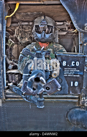 High dynamic range image of a UH-60 Black Hawk door gunner manning a ...