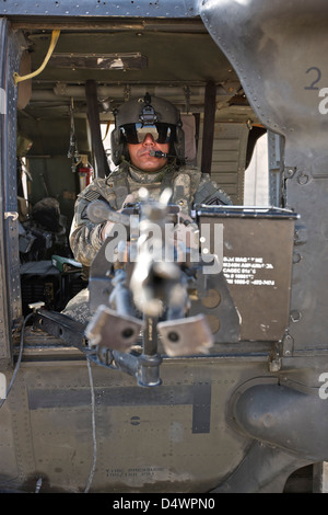 A UH-60 Black Hawk door gunner manning a M240B machine gun, Tikrit ...