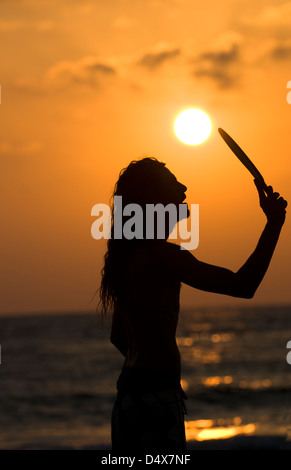 Playing Matkot ( beach paddle ball game ) during sunset on the beach in ...