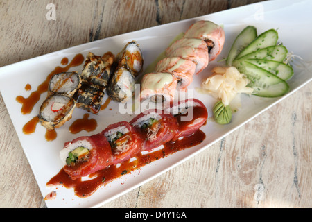 Different Sushi served on japanese knife on a black slate plate . flat ...