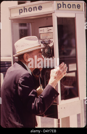 This photograph shows a man using a telephone at the C & P Telephone ...