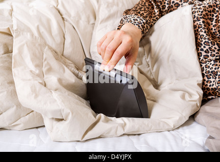 Female hand with alarm clock at home, closeup. Daylight saving time ...