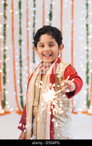 Boy burning fire crackers on Diwali Stock Photo - Alamy