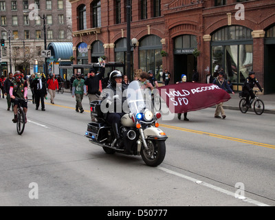 Seattle Police Department motorcycle cop stops traffic at an Anti ...