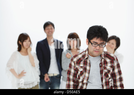 Man getting excluded from a group Stock Photo - Alamy