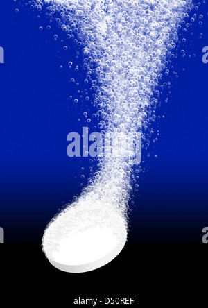 Tablet fizzing in blue water, close up Stock Photo - Alamy