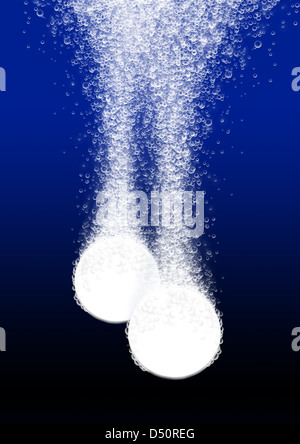 Tablet fizzing in black background Stock Photo - Alamy