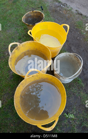 Two Buckets In Construction Site. Two empty buckets near dirty used ...