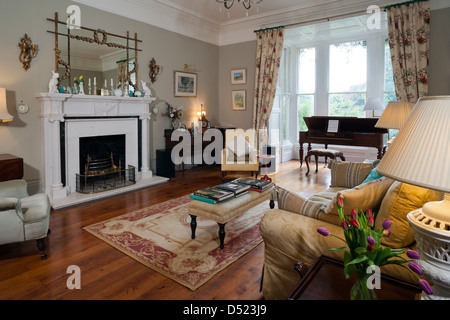 UK. A large traditional formal drawing room with a grand piano Stock ...