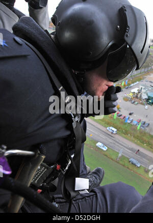 A police officer observes the area from a watch tower of district ...