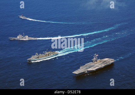 US Navy USNS Rainier (T-AOE 7), center, is met by the Nimitz-class ...