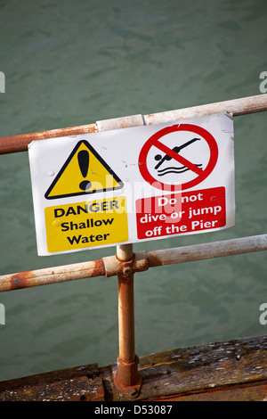 "Danger Shallow Water" and "Do not dive or jump off the Pier" warning ...