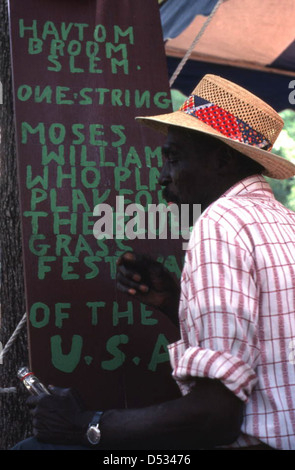 Moses Williams, a traditional musician, is shown playing the diddley ...