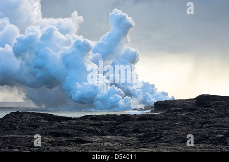 Steam rising into the sky from lava from the Kilauea volcano in Hawaii ...