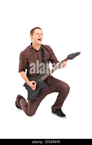 Full length portrait of a rock star playing guitar isolated on white ...