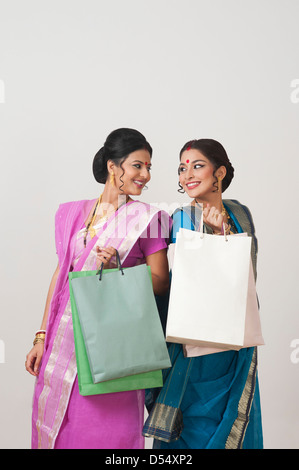 Bengali woman holding shopping bag and smiling Stock Photo - Alamy