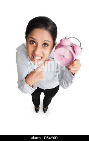 businesswoman pointing at clock in office Stock Photo - Alamy