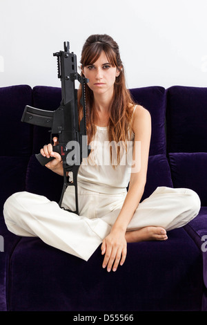 Gun on sofa Stock Photo - Alamy