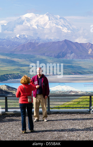 A visitor photographs a family at Denali National Park, capturing the ...