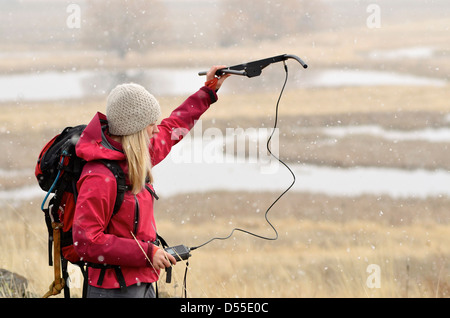 Researcher using radio telemetry to track wildlife in Oregon's Grande ...
