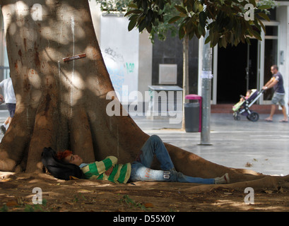 homeless man sleeping under tree, chinatown, bangkok, thailand Stock ...